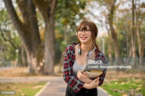 아름다운 아시아 여학생이 노트북과 교과서를 들고 공원을 따라 걷고 있다 25 29세에 대한 스톡 사진 및 기타 이미지 25 29세 걷기 공부 Istock