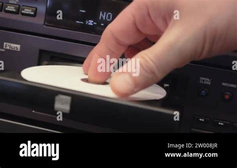 inserting a blank cd disk into the cd recorder and closing the tray 2