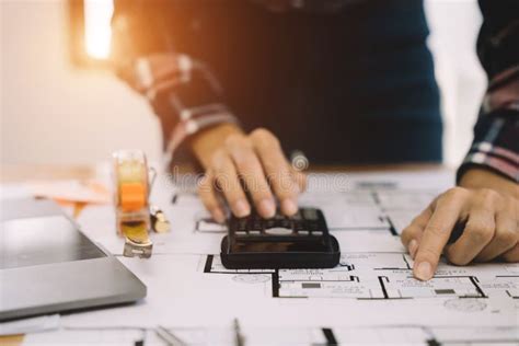 Civil Engineer Or Architect Business Useing Calculator About Calculate The Cost With For Working