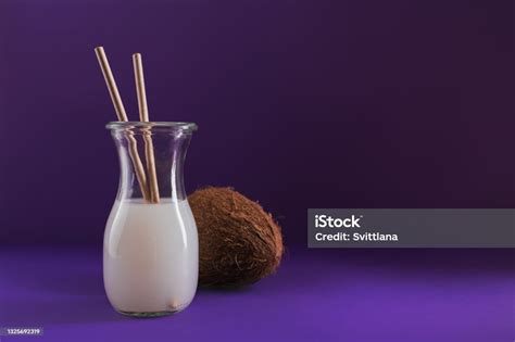 보라색 배경에 흩어져 있는 코코넛 비건 우유 한 병과 코코넛 전체 건강한 라이프 스타일 개념 건강관리와 의술에 대한 스톡 사진 및 기타 이미지 Istock