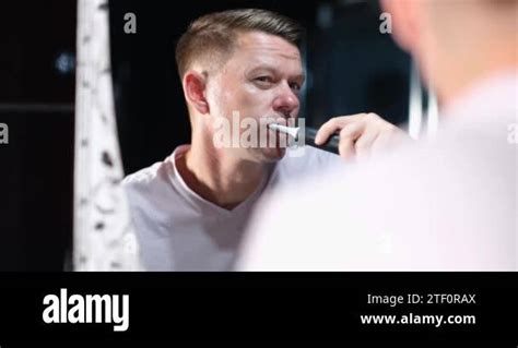 Focused Handsome Young Man Electric Brushing Teeth In Front Of Mirror Algorithm For Proper