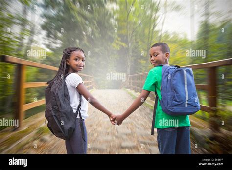 Composite Image Of Cute Pupils Holding Hands Stock Photo Alamy