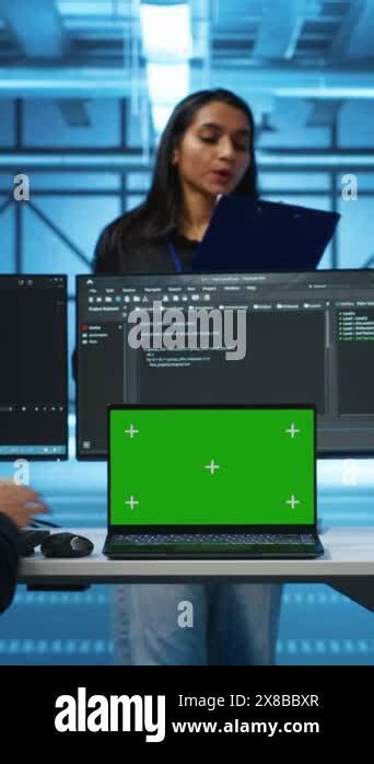 Vertical Video Isolated Screen Laptop In Front Of It Support Workers Coding On Computers And