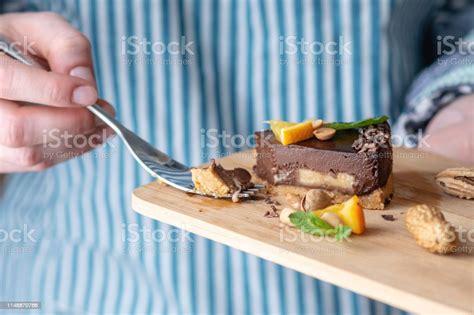 오렌지 민트 잎과 견과류와 초콜릿 케이크의 조각을 포크로 손 나누기 채식주의자를 위한 건강 한 생 디저트 개념에 대한 스톡 사진 및 기타 이미지 Istock