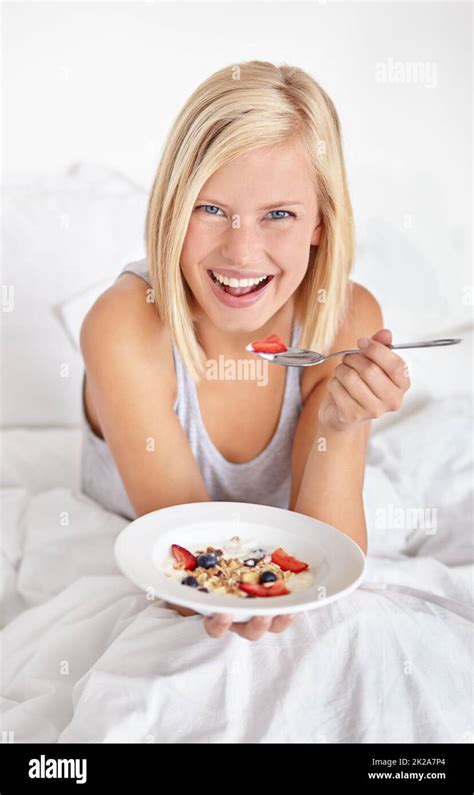 Breakfast In Bed An Attractive Young Woman Eating Her Breakfast In Bed