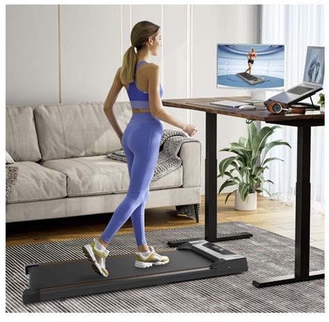 A Woman Standing On A Treadmill In Front Of A Computer Desk With A Laptop