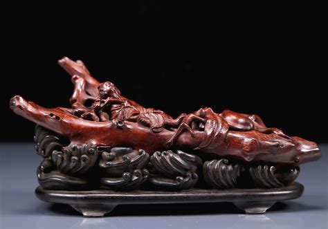 An Exquisite Huanghuali Wood Figure Ornament With Zitanwood Base Auction