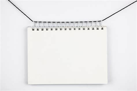 premium photo white blank notepad blank hanging on a rope on an
