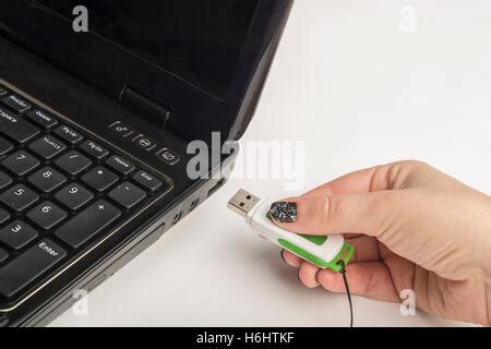 Hand Inserting Usb Memory Stick To Laptop Computer Stock Photo Alamy