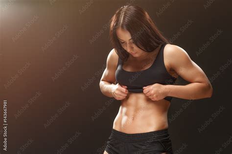 Perfect Abs Horizontal Shot Of A Gorgeous Female Athlete Posing At The Studio Looking At Her