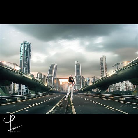 A Picture Of A Girl Standing On A Bridge With A Bridge In The