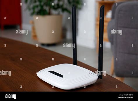 Modern Wi Fi Router On Wooden Table Indoors Space For Text Stock Photo Alamy