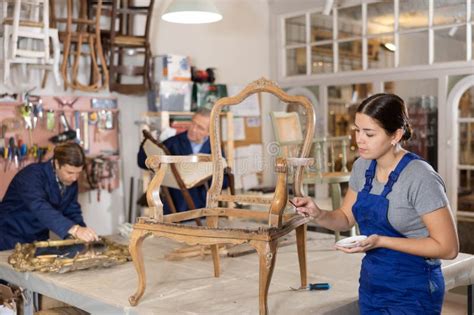 Female Positive Restorer Restores The Wooden Frame Of An Antique Chair Female Positive Restorer Restores The Wooden Frame Of An Antique Chair
