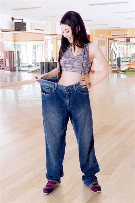 Premium Photo Portrait Of Happy Chinese Woman Trying Her Old Jeans