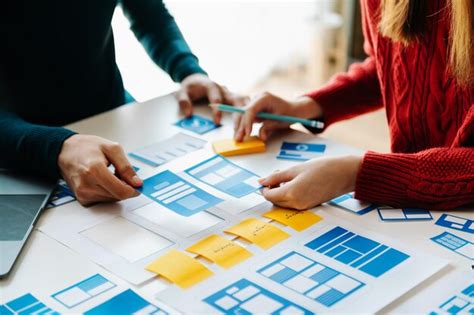Premium Photo Ux Developer And Ui Designer Brainstorming About Mobile App Interface Wireframe
