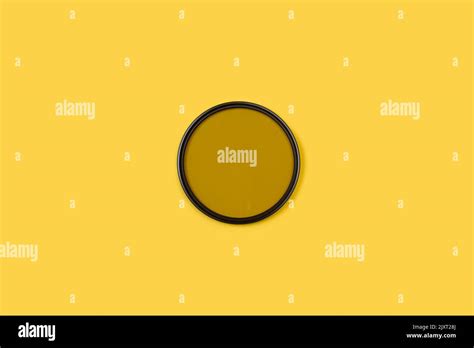 A Photography Polarizing Filter On A Yellow Background With Copy Space