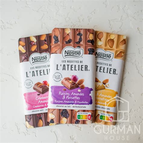 Купить Крафтовый швейцарский шоколад Nestle L`atelier молочный с изюмом миндалем и лесным