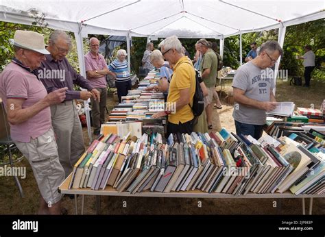 Senior People Buying Second Hand Books At A Second Hand Book Stall The Annual Village Fete