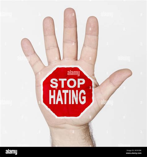 On The Palm Of The Hand There Is A Stop Sign With The Inscription Stop Hating Isolated On