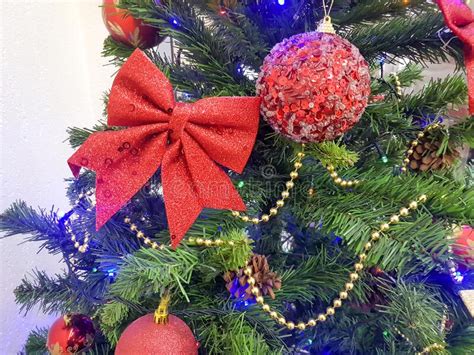 Close Up Of A Christmas Tree Decorated With Bows Sparkling Glass Balls And Christmas Tree Toys