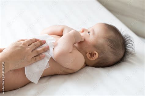 Mom Cleaning Up And Wipe Body Baby By Wet Tissue When Changing Nappies Or Diaper And Wiping The