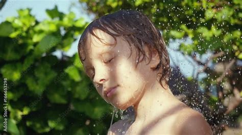 Boy Playing With Water In The Garden Boy Has A Shower Washing Hair In Slow Motion Outdoor In