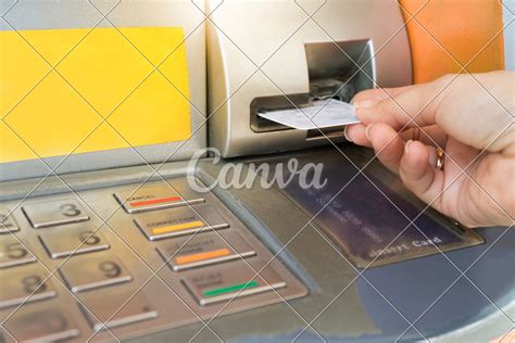 Hand Inserting ATM Card Into Bank Machine Photos By Canva