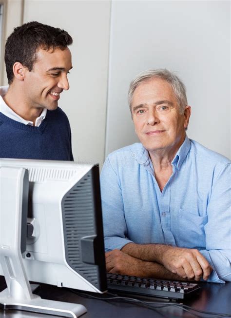 Senior Man With Male Teacher In Computer Class Stock Image Image Of