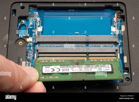 Inserting A Typical Ram Memory Module Into A Memory Socket In A Laptop Module Is Placed In The