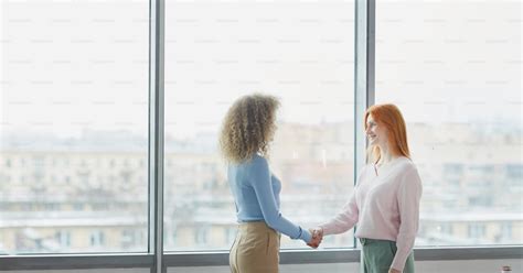 두 명의 성공적인 젊은 사업가가 면접이나 거래 후 악수하는 모습의 측면 초상화 현대 사무실의 창가에 서 있는 동안 공간을 복사합니다 사진 Unsplash의 사업 이미지