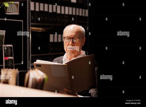 Tired Police Officer Reading Confidential Federal Files Working Overtime At Criminal Case In