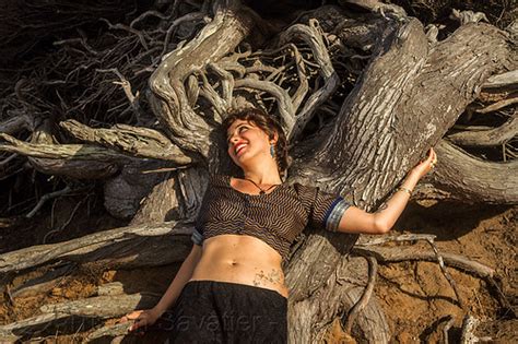 Woman Laying On Twisted Juniper Tree Roots
