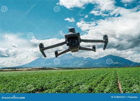 Aerial View Of A Drone Moderning Over Farm Fields Monitoring Analyzing Crop Health