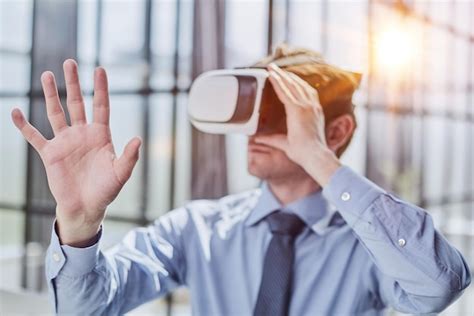 Premium Photo Young Man Testing Vr Glasses Or Goggles Sitting In The