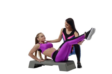 Premium Photo Fitness Coach Helping Girl Do Exercise On Stepper