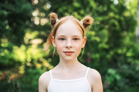 Portrait Of Redhead Girl With Freckles On Summer Blurred Background