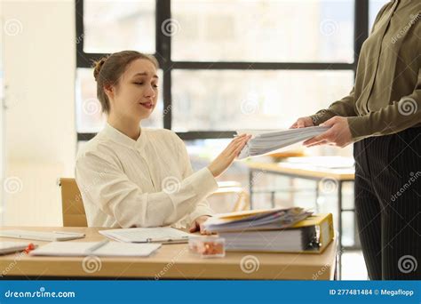 Employee Giving Pack Of Documents To Manager Extra Work For Executor
