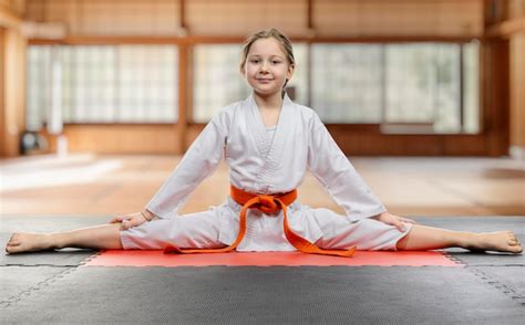 Premium Photo Young Girl Practicing Karate Split In Dojo
