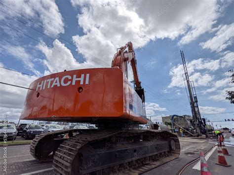 Constructing Progress Hitachi Excavator And Workers On A Busy Street Stock Photo Adobe Stock