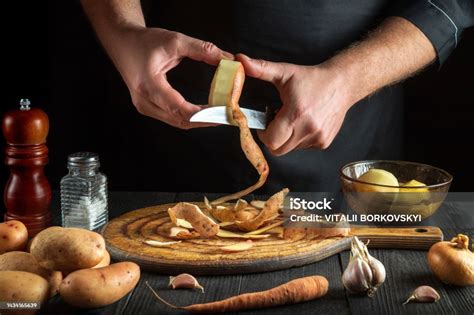 전문 요리사가 감자 튀김을 위해 감자를 껍질을 벗깁니다 감자 요리를 위해 메뉴 요리 건강 식품에 대한 검은 배경 개념 무료 광고