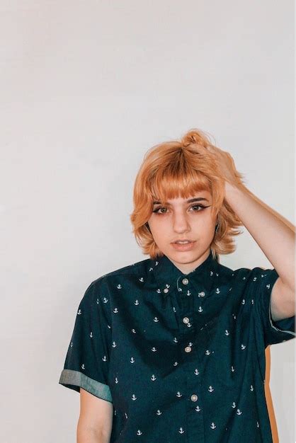 Premium Photo Portrait Of Young Woman With Redhead Standing Against
