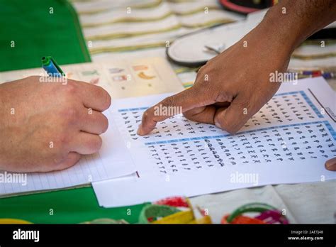 A Man Learns How To Write The Geez Script The Letters Of The Ethiopian Alphabet Silver Spring