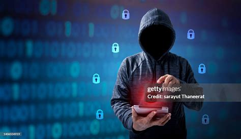 hacker in hoodie dark theme hacker in a blue hoody standing in front of a coding background with