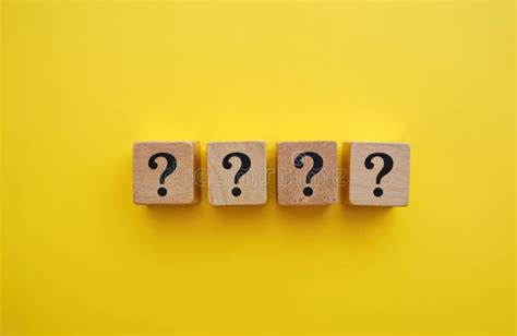 wooden blocks with question marks on bright yellow background simple