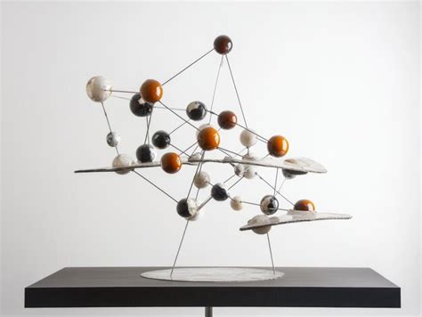 Modern Abstract Sculpture Of Interconnected Spheres On Minimalist Base Premium Ai Generated Image