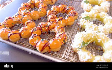 Assorted Mochi Donuts Displayed On Baking Trays Ready To Enjoy Stock