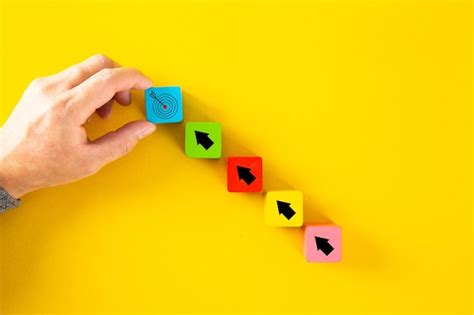 Premium Photo Hand Putting Virtual Target Board And Arrow On Wooden Cube