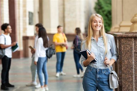 Happy Girl Posing To Camera With Books In College Campus Stock Image