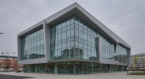 Modern Glass Building With Angular Design Featuring Large Reflective