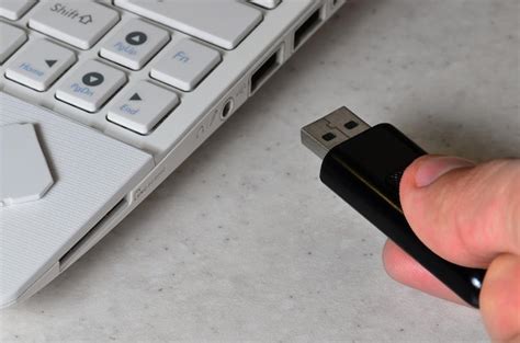 Premium Photo Cropped Hand Inserting Usb Stick In Laptop